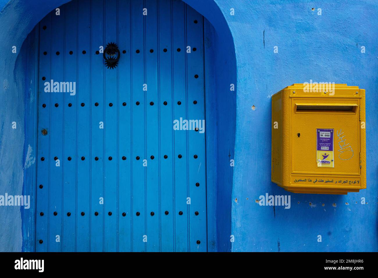 North Africa. Morocco. Chefchaouen. Yellow letter box on the blue wall ...