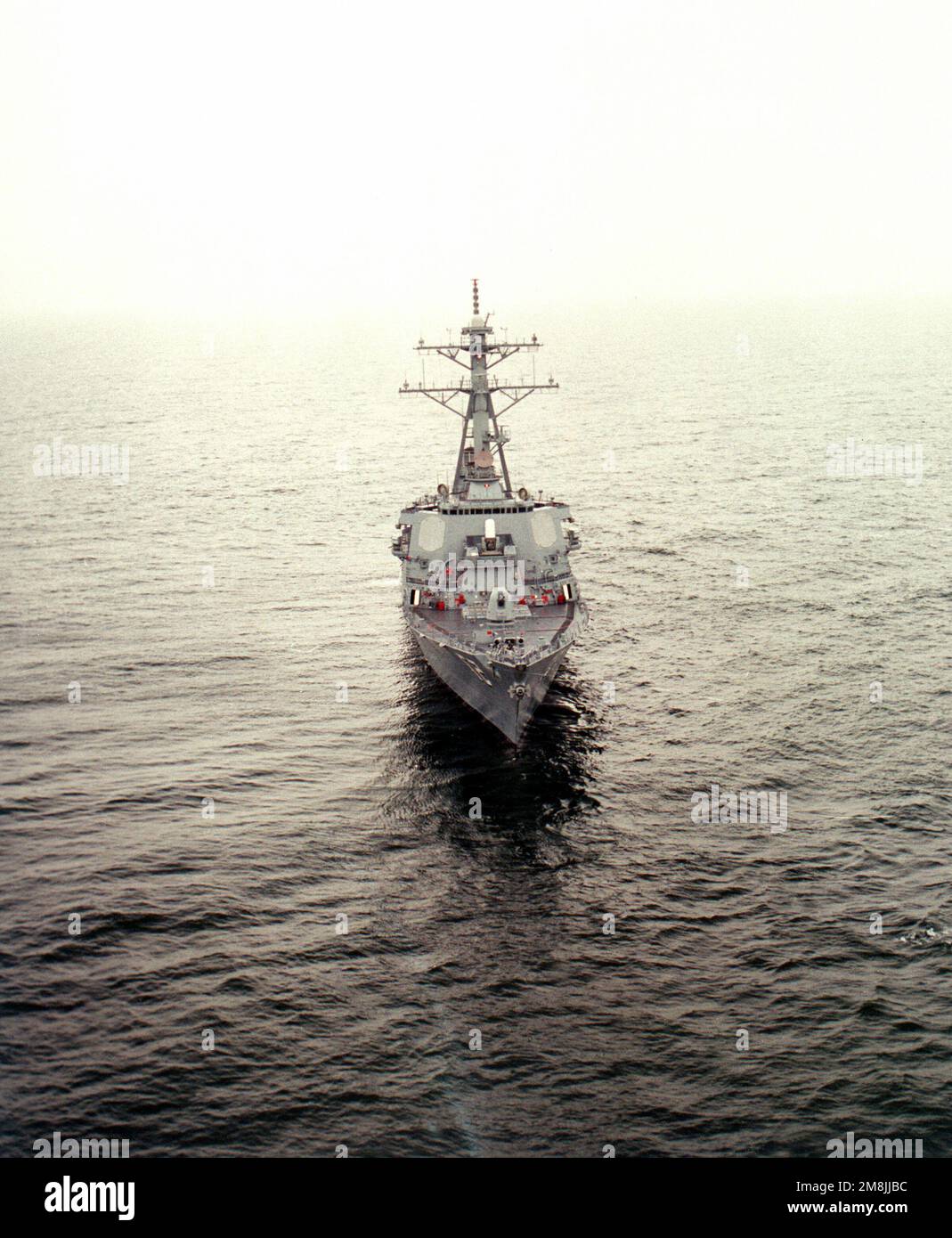 An aerial low oblique bow-on view of the guided missile destroyer USS ...
