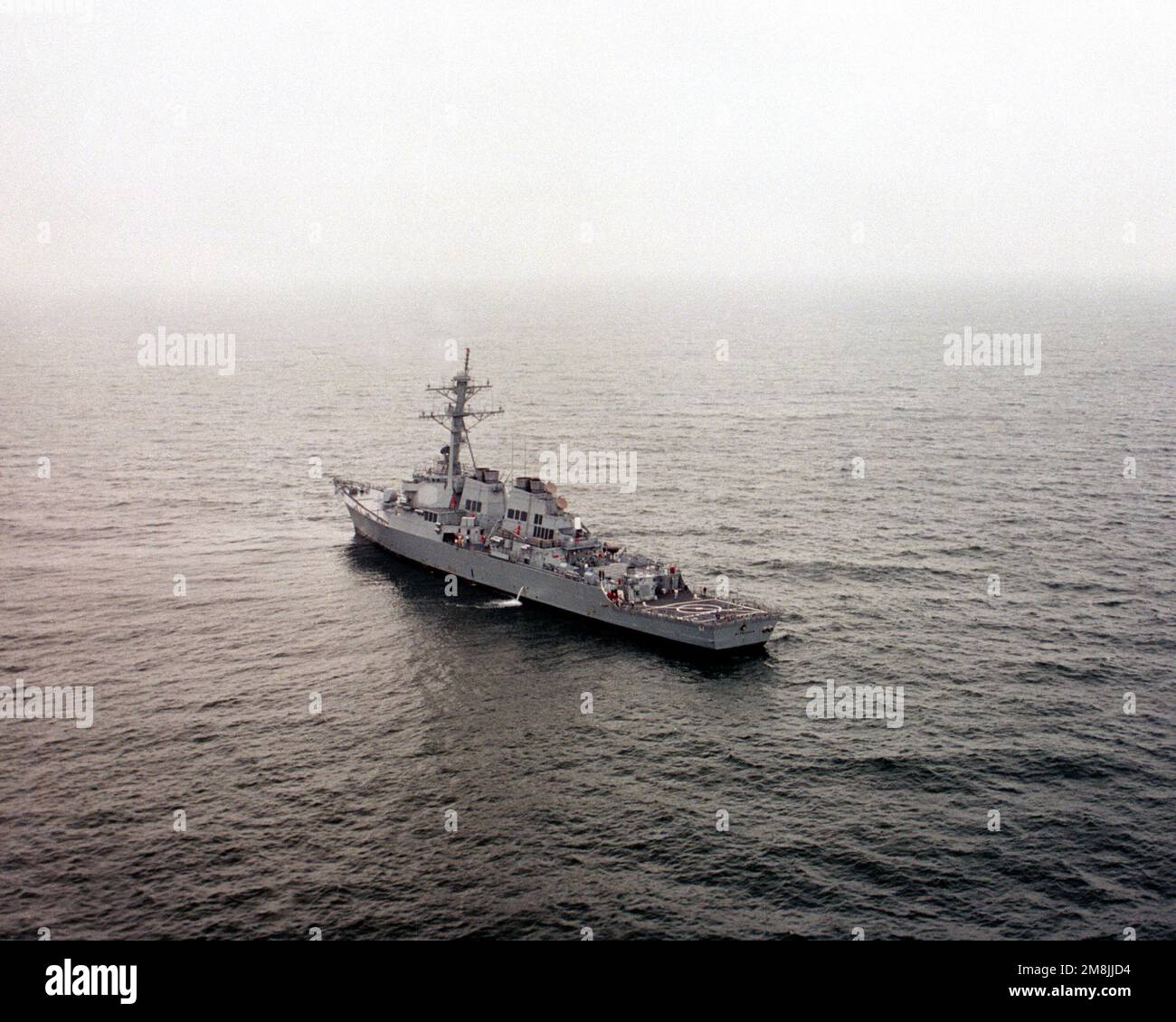 An aerial low oblique port quarter view of the guided missile destroyer ...