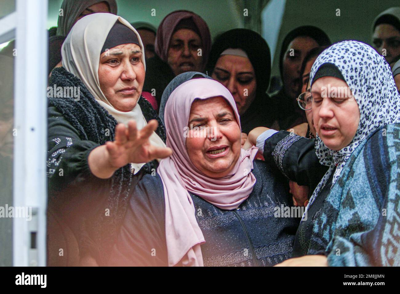 Jenin, Palestine. 14th Jan, 2023. Relatives mourn during the funeral ...