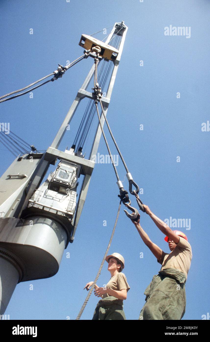 PVT Tabatha Roberts and PVT Cassey Cassidi adjust the rigging on a 50 ...