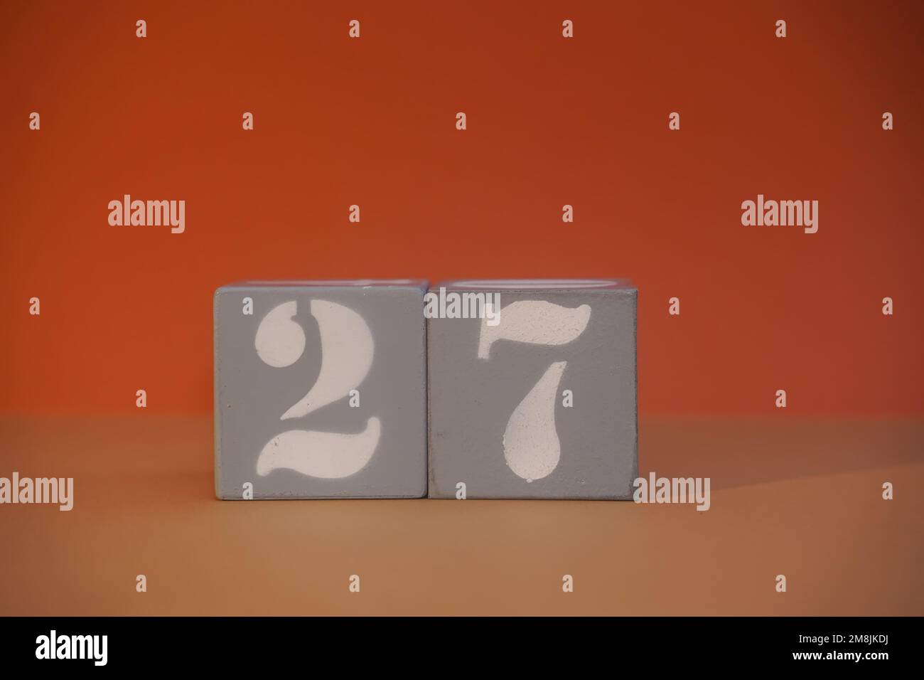 Number 27 on wooden grey cubes. Concept of date time. Math concept ...