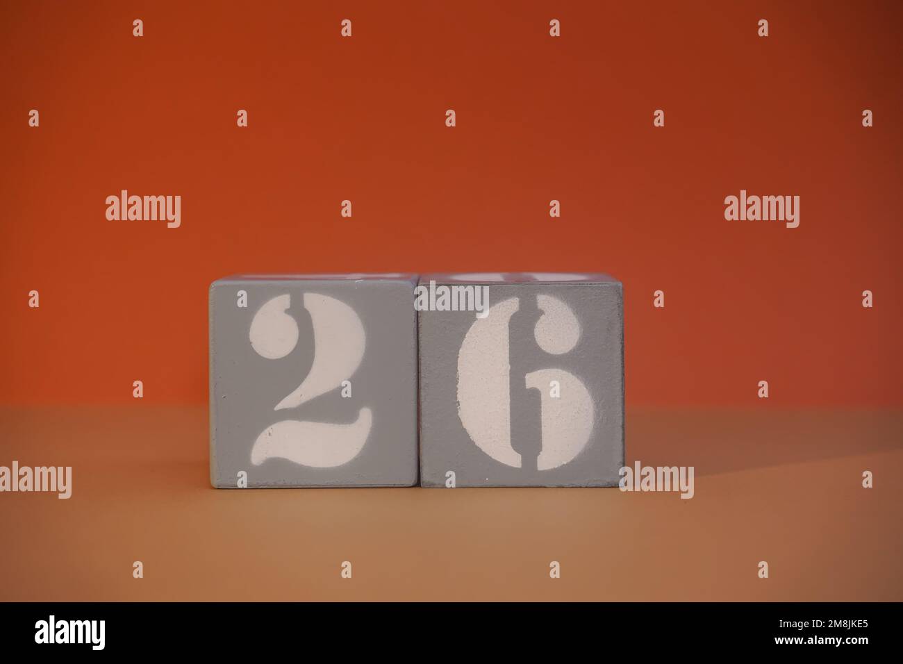 Number 26 on wooden grey cubes. Concept of date time. Math concept ...
