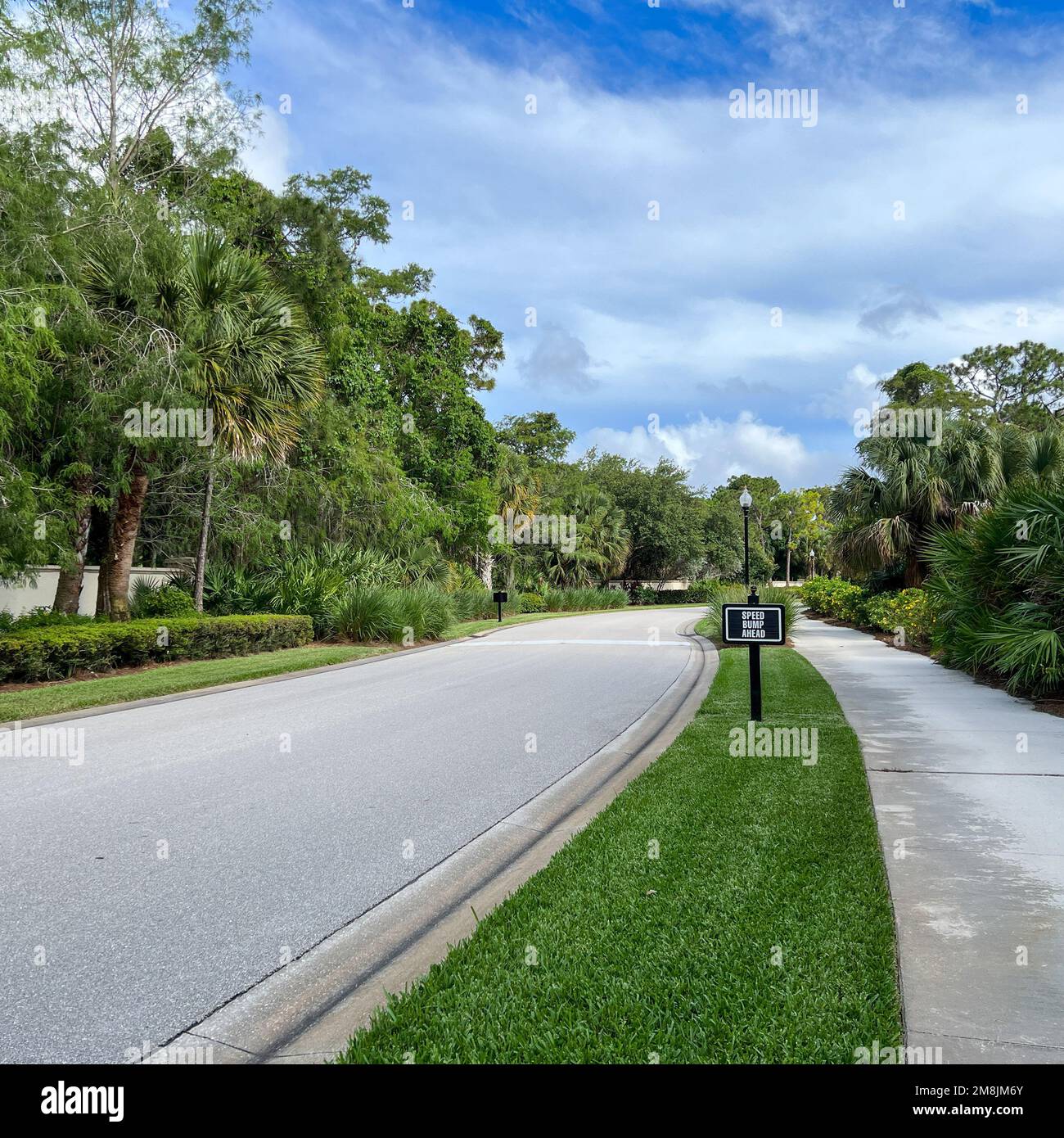 A Speed Bump Ahead Sign In A Neighborhood Used To Slow Down Cars On a-speed-bump-ahead-sign-in-a-neighborhood-used-to-slow-down-cars-on