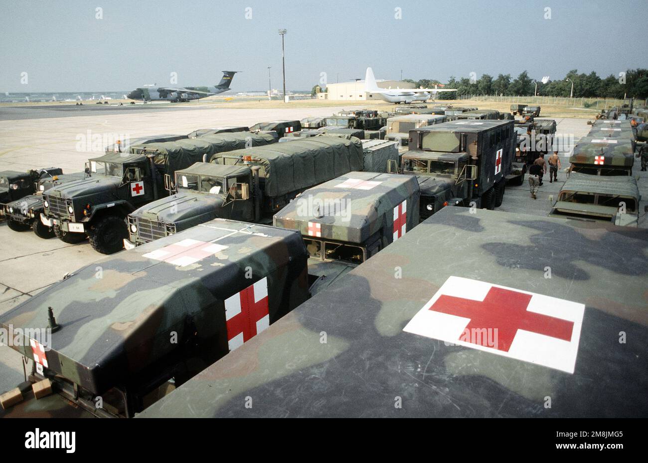 U.S. Army trucks, identified as medical relief with a red cross, in the ...