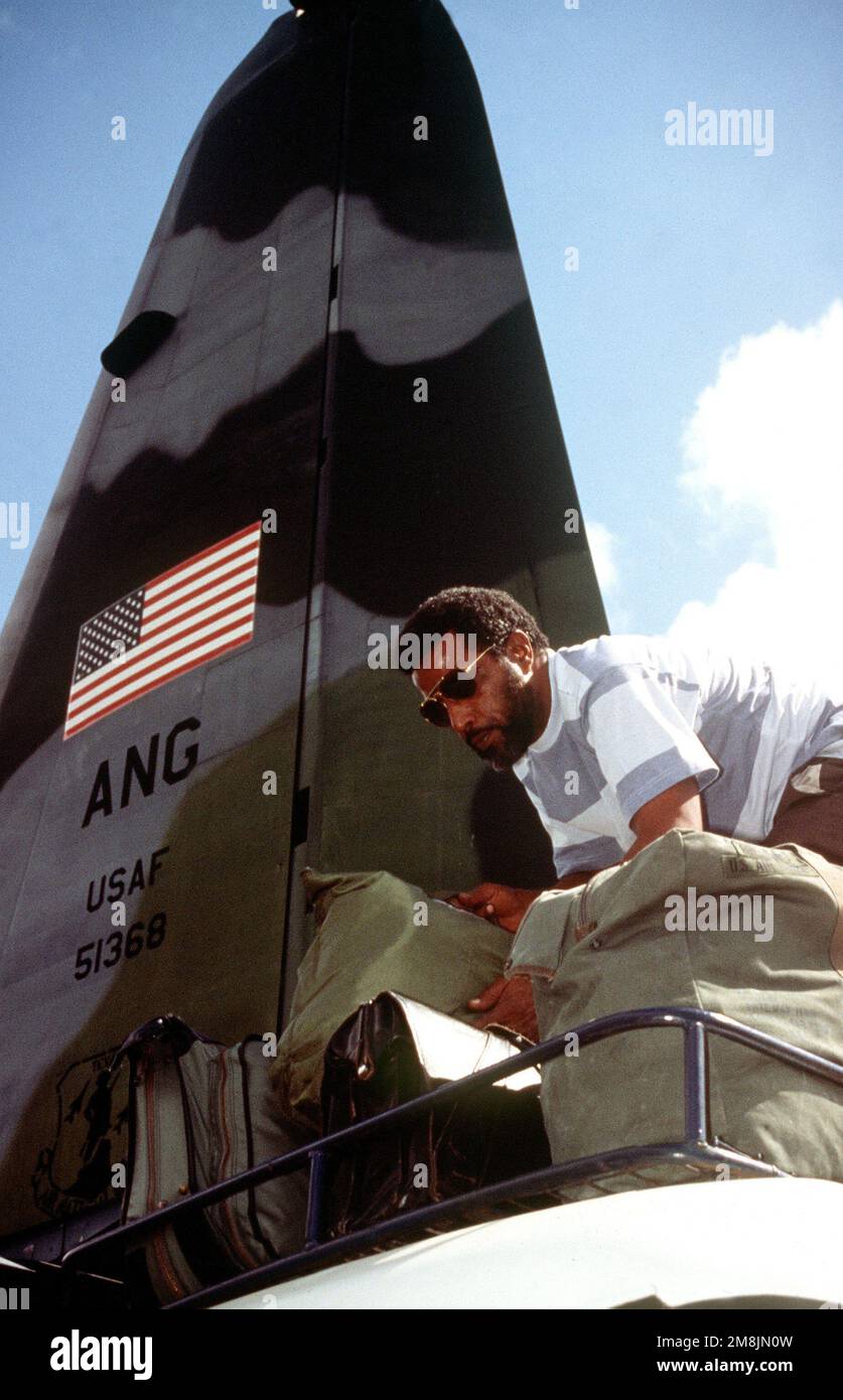 A local helps off load a C-130 from the 136th Air Wing, Dallas Naval ...