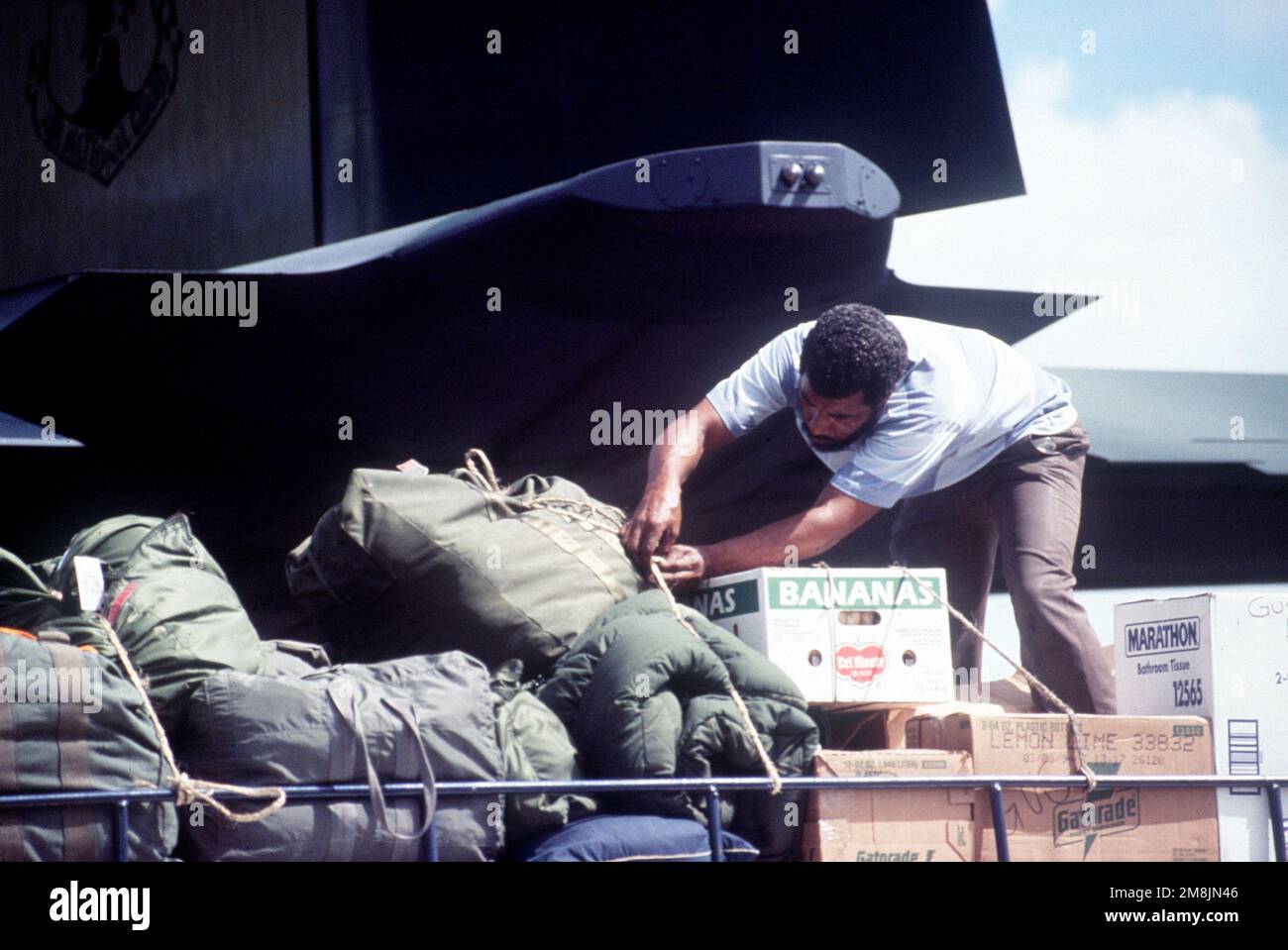 A local from Mombasa, Kenya helps off load a C-130 out of the 136th Air ...