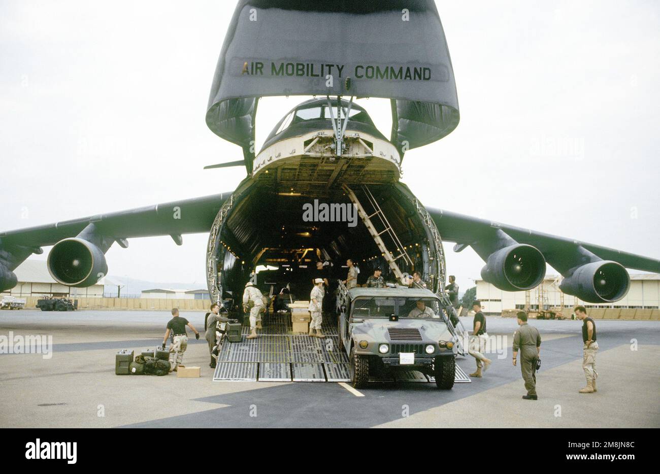 A High-Mobility Multipurpose Wheeled Vehicle (HMMWV) is off loaded from ...