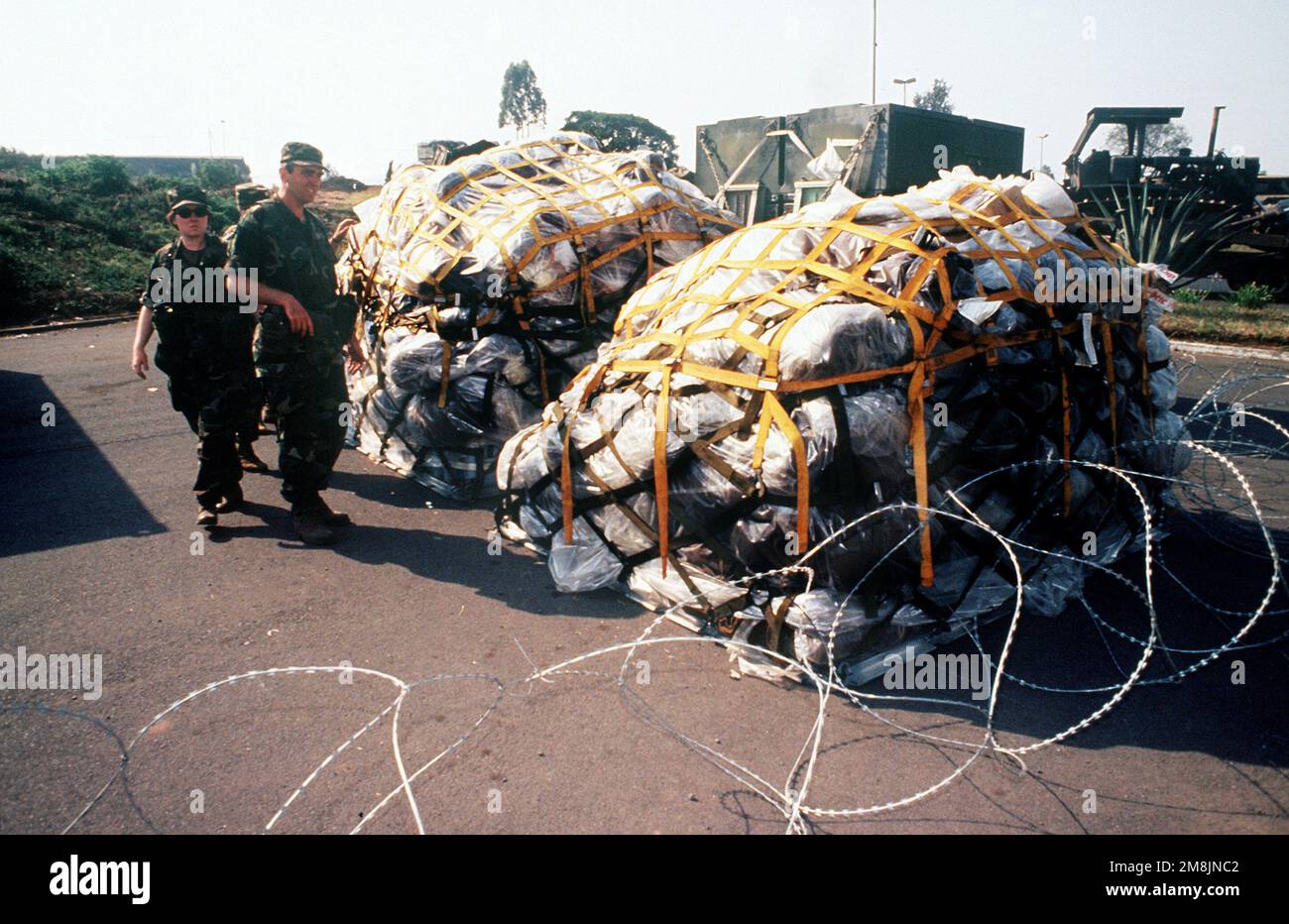US Military personnel inspect cargo pallet. The pallet contain relief ...
