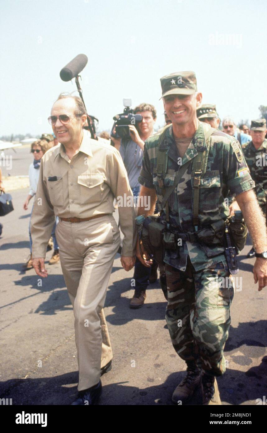 Secretary of Defense William Perry and Brig. GEN. Jack Nix visit the refugee camps at Goma ...