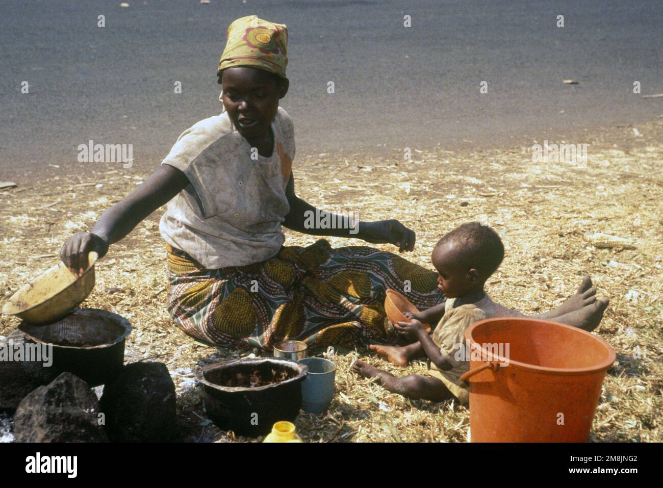 A Rwandan mother feeds her child. Rwandan refugees entered Goma after a ...