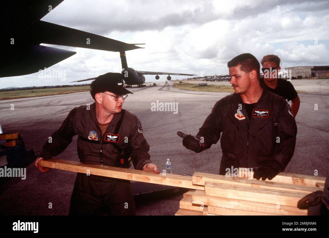 SENIOR AIRMAN Larry Perrault, a load master and SENIOR AIRMAN Steve ...