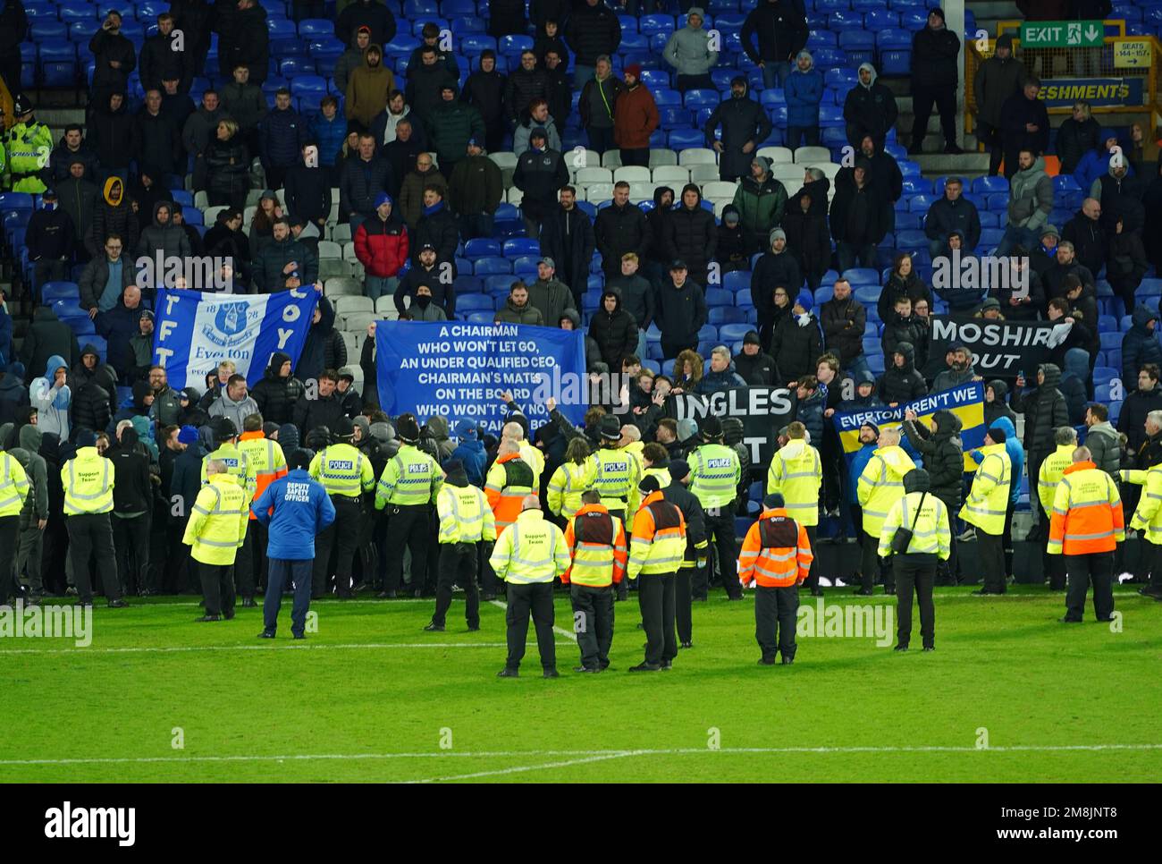 Everton fans hold up banners in protest against the clubs board after ...