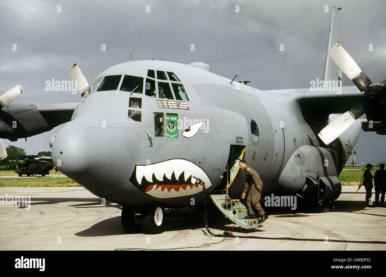 A crewmember boards a C-130 Hercules from the 41st Airlift Squadron ...