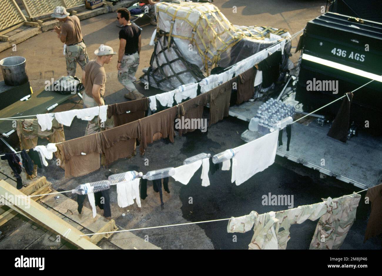 In a makeshift laundry on the flight line ramp members of the 436th ...