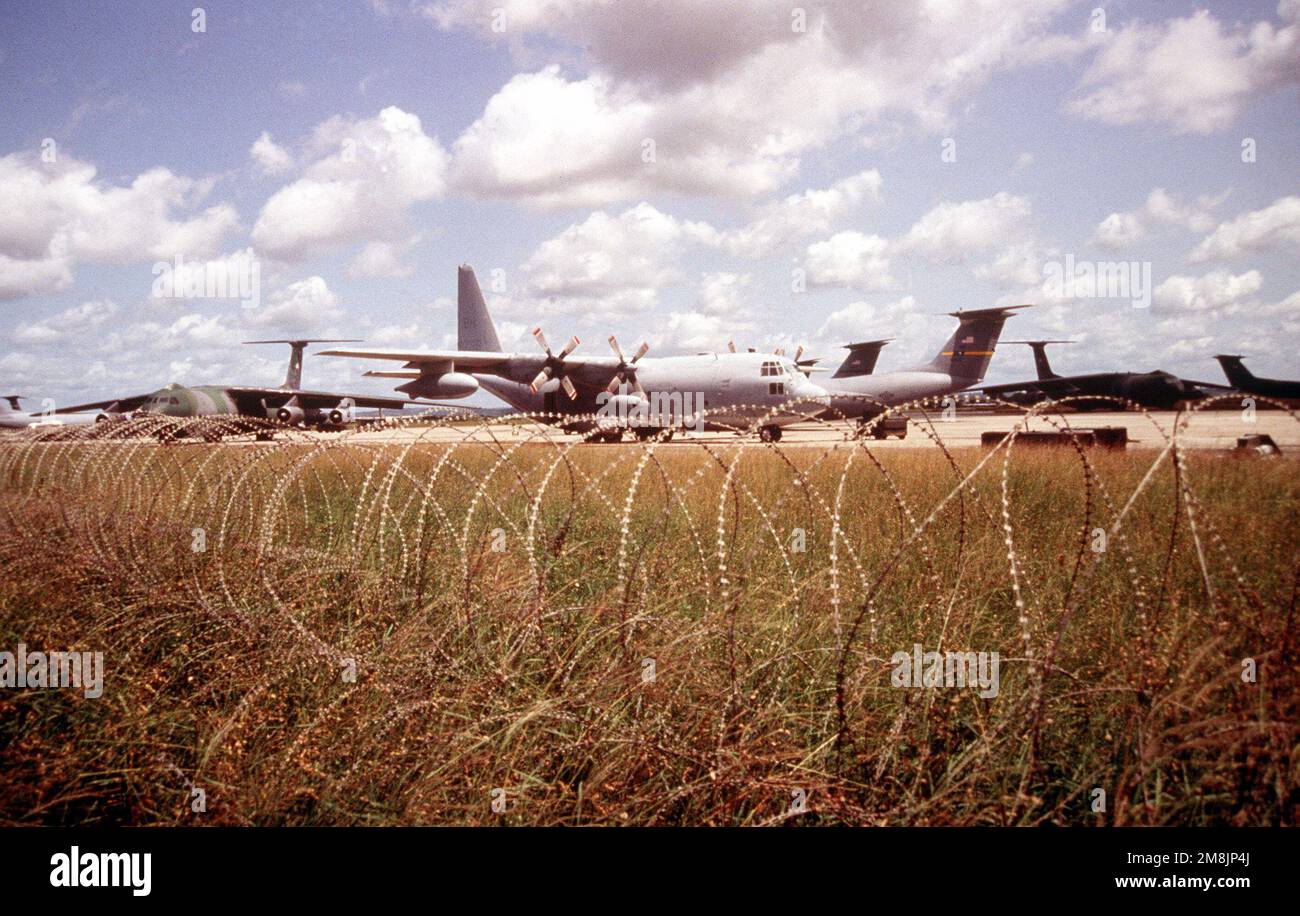 Concertina wire surrounds C-5 Galaxys, C-141 Starlifters, and C-130 ...