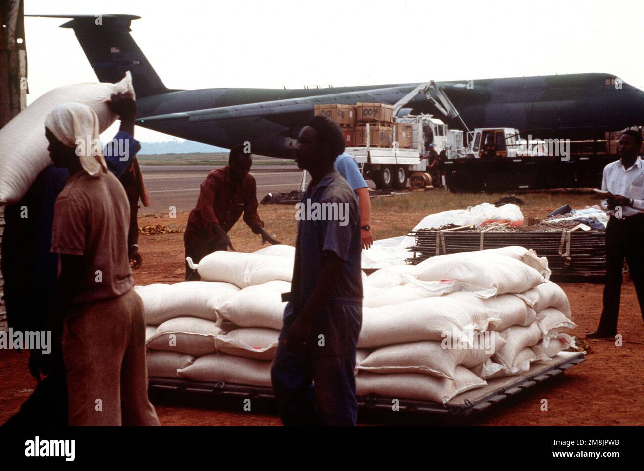 Workers at the Entebbe International Airport unload relief supplies ...