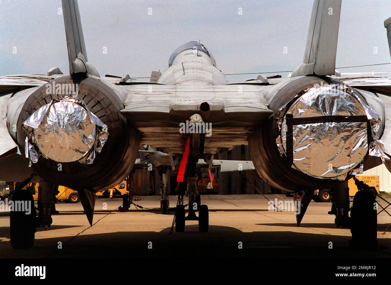A rear view of an F-14A Tomcat aircraft of Fighter Squadron 103 (VF-103) parked on the flight ...