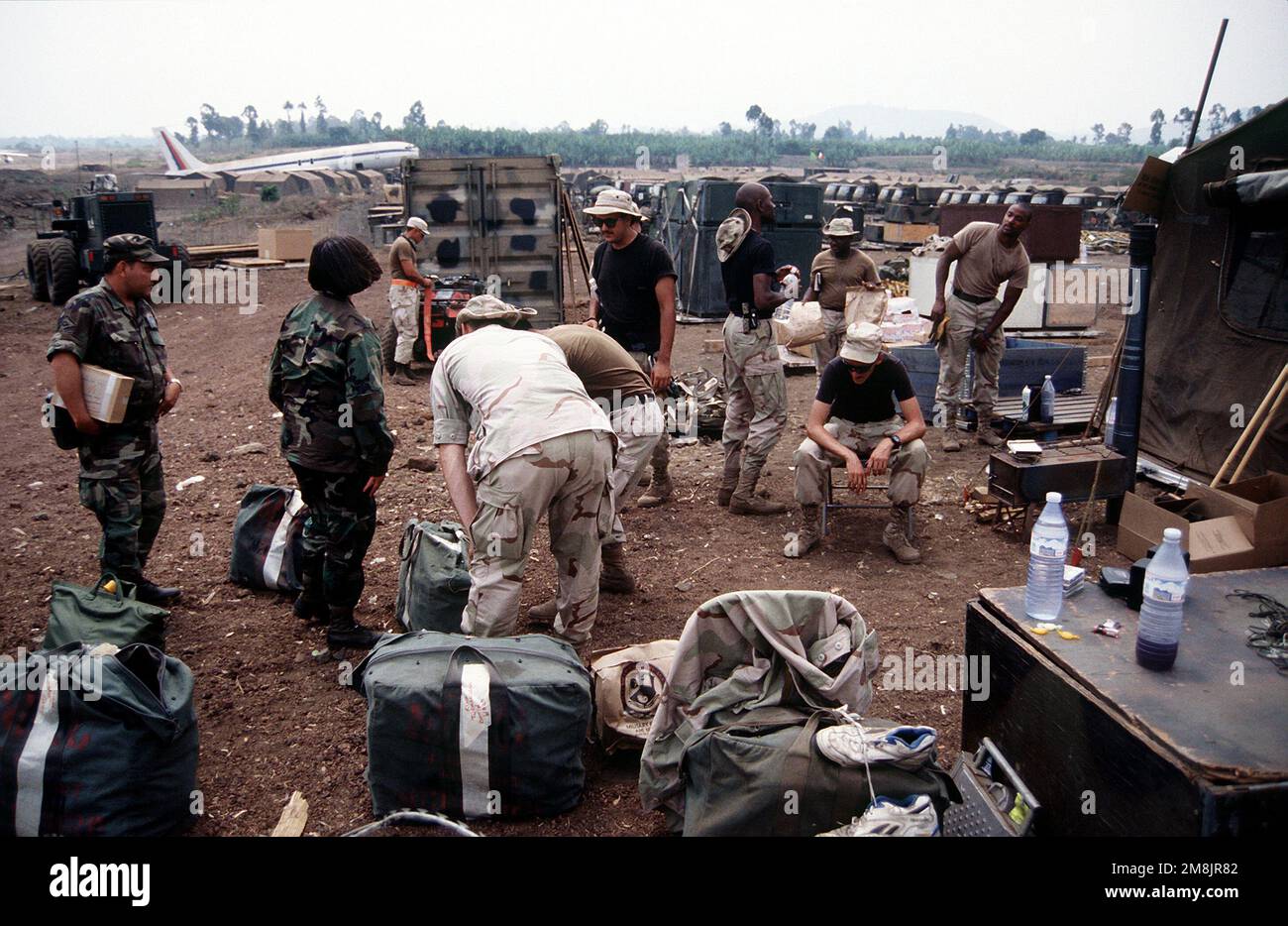 Newly arrived American military troops check over their bags after ...