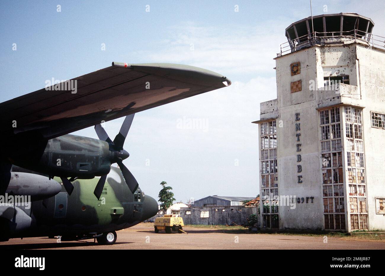 C-130 Hercules on the ramp in front of control tower at Entebbe Airport ...