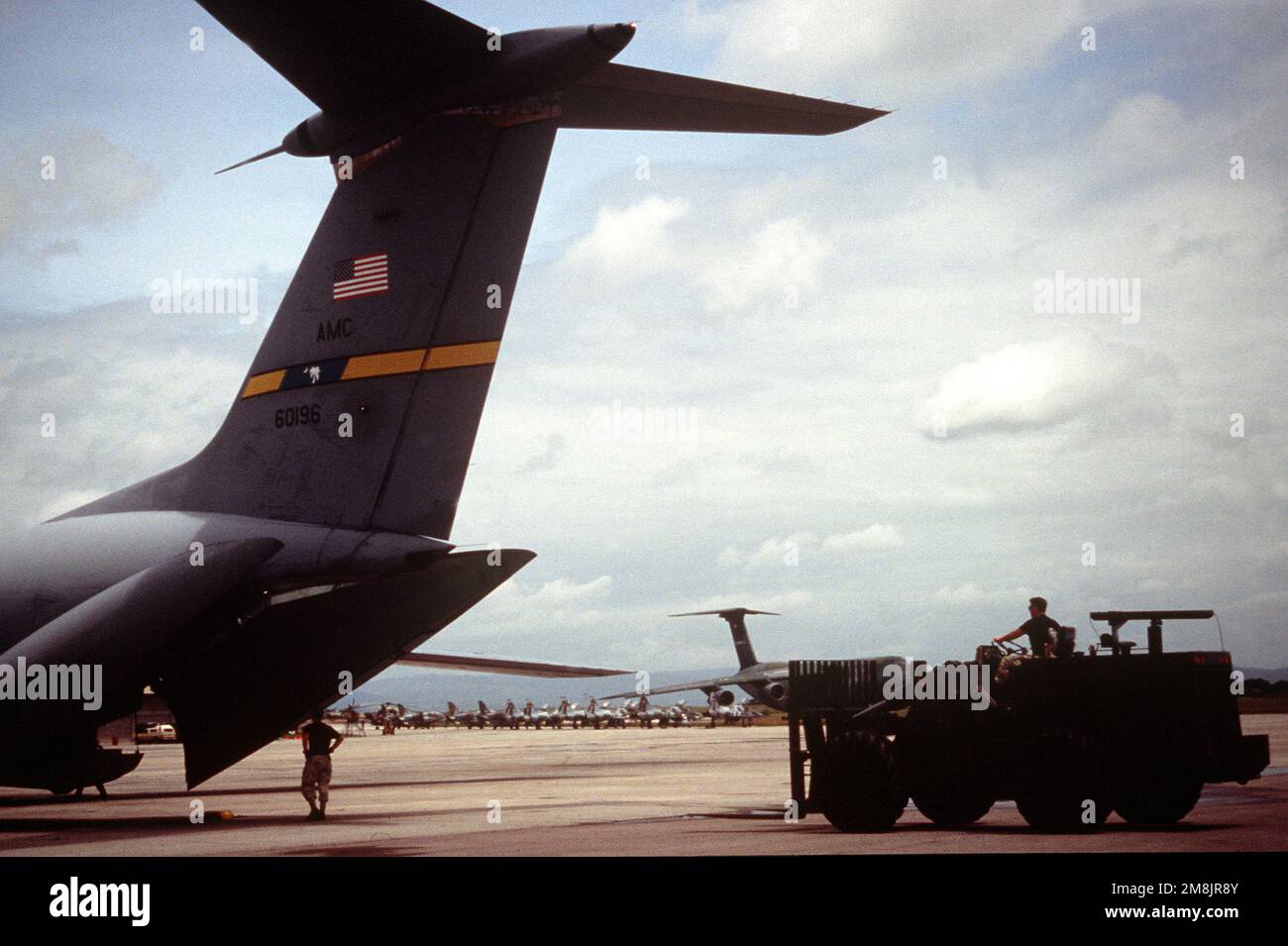 A 10K forklift off loads equipment from a C-141 Starlifter. The ...