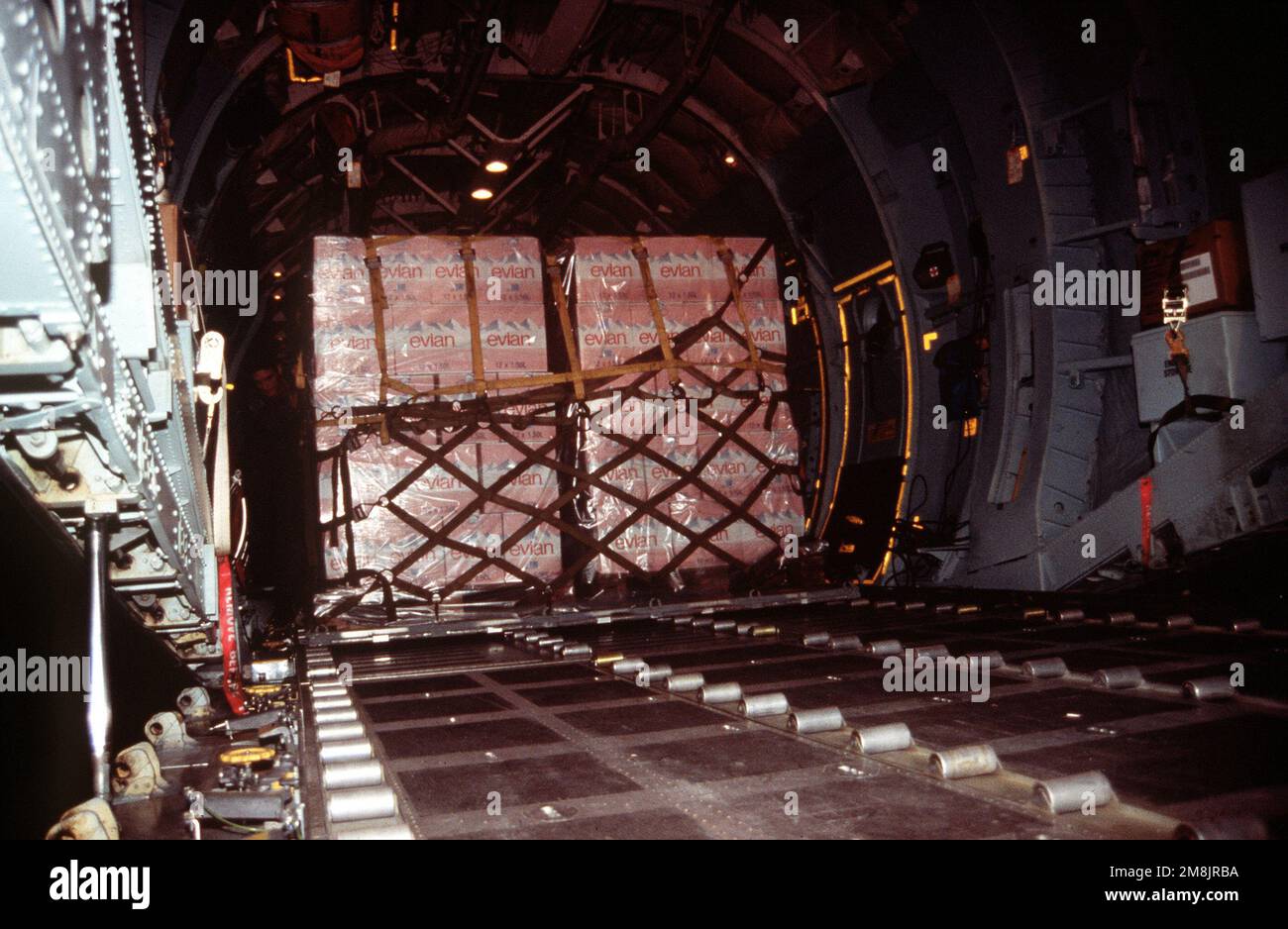 Cargo is off-loaded from a C-141 Starlifter aircraft at night at an ...