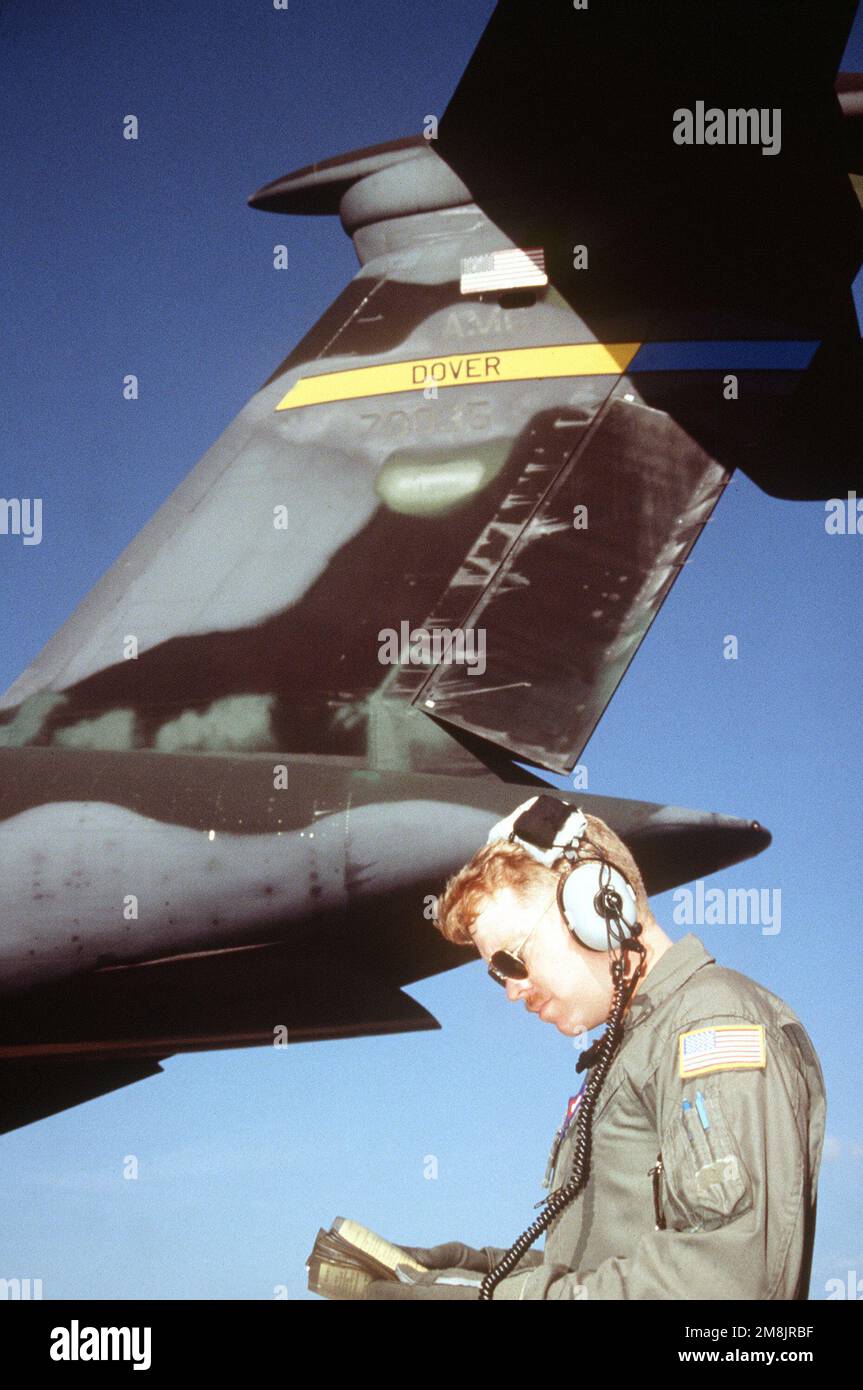A C-141 aircraft flight engineer from the 14th Airlift Squadron (ALS ...