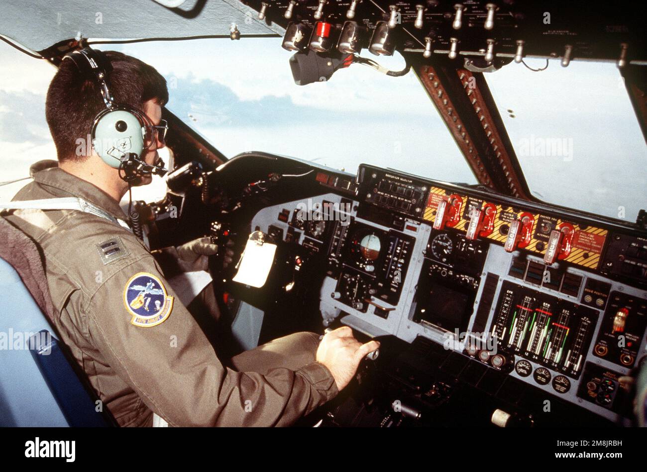 A view of a pilot in the cockpit of a C-141 Starlifter. The ...