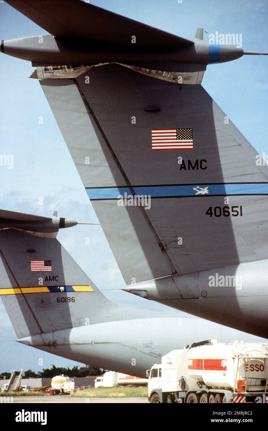 A view of the tail section of two C-141 Starlifters sitting at Moi ...
