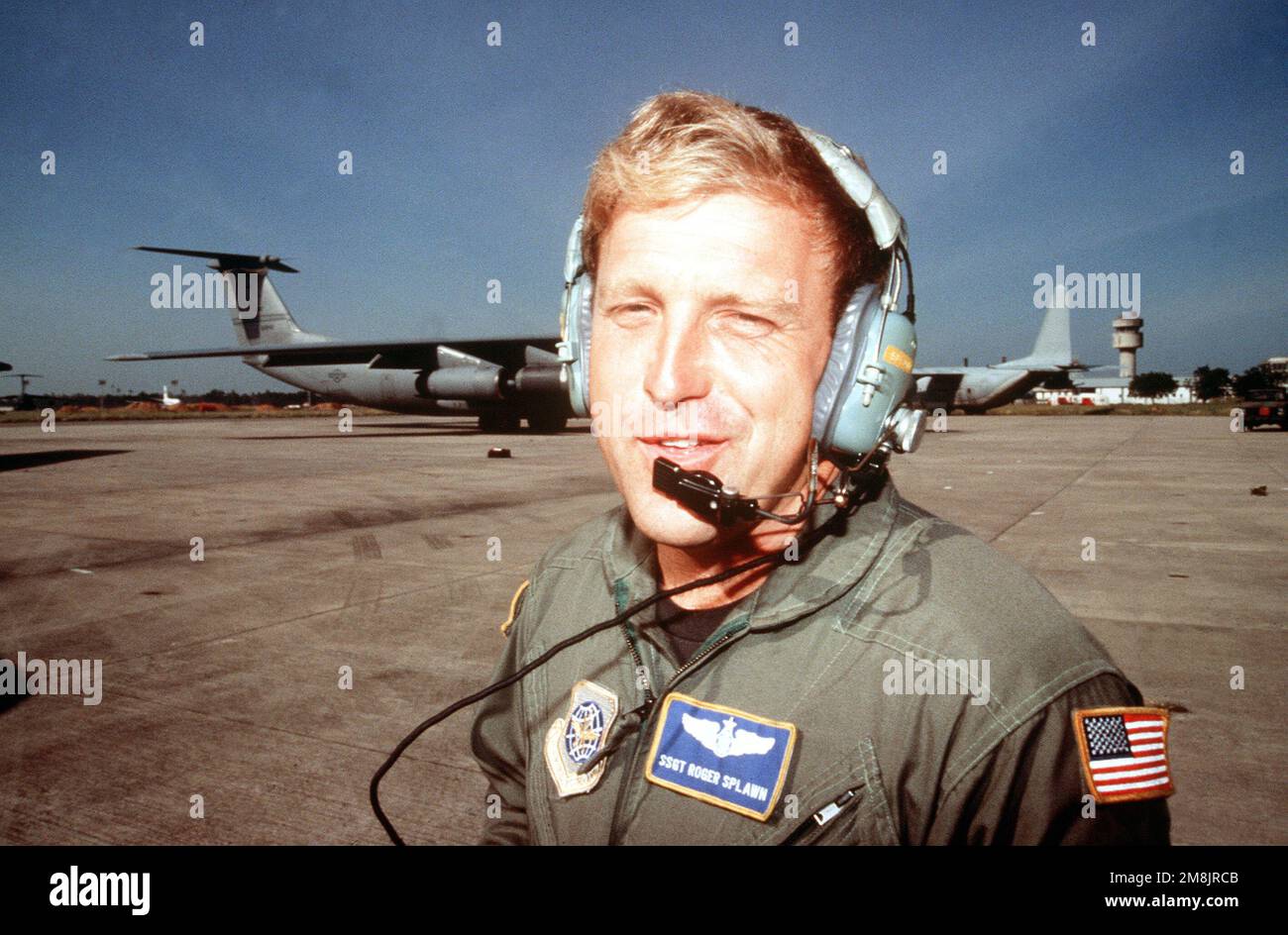 A head and shoulders shot of STAFF SGT. Roger Splawn wearing a headset ...