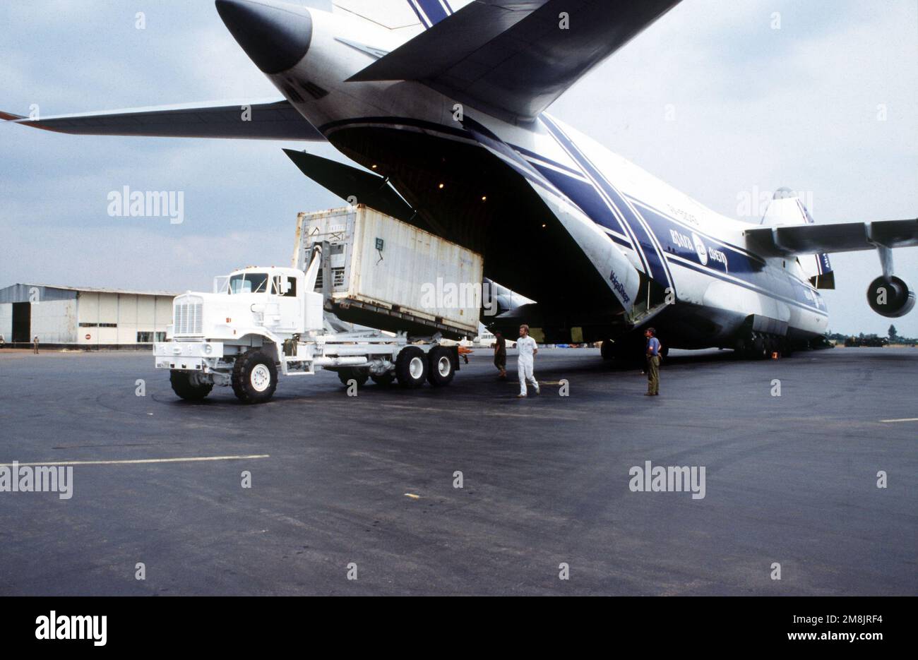 A container is taken off of a Russian AN-124 transport at the airport ...