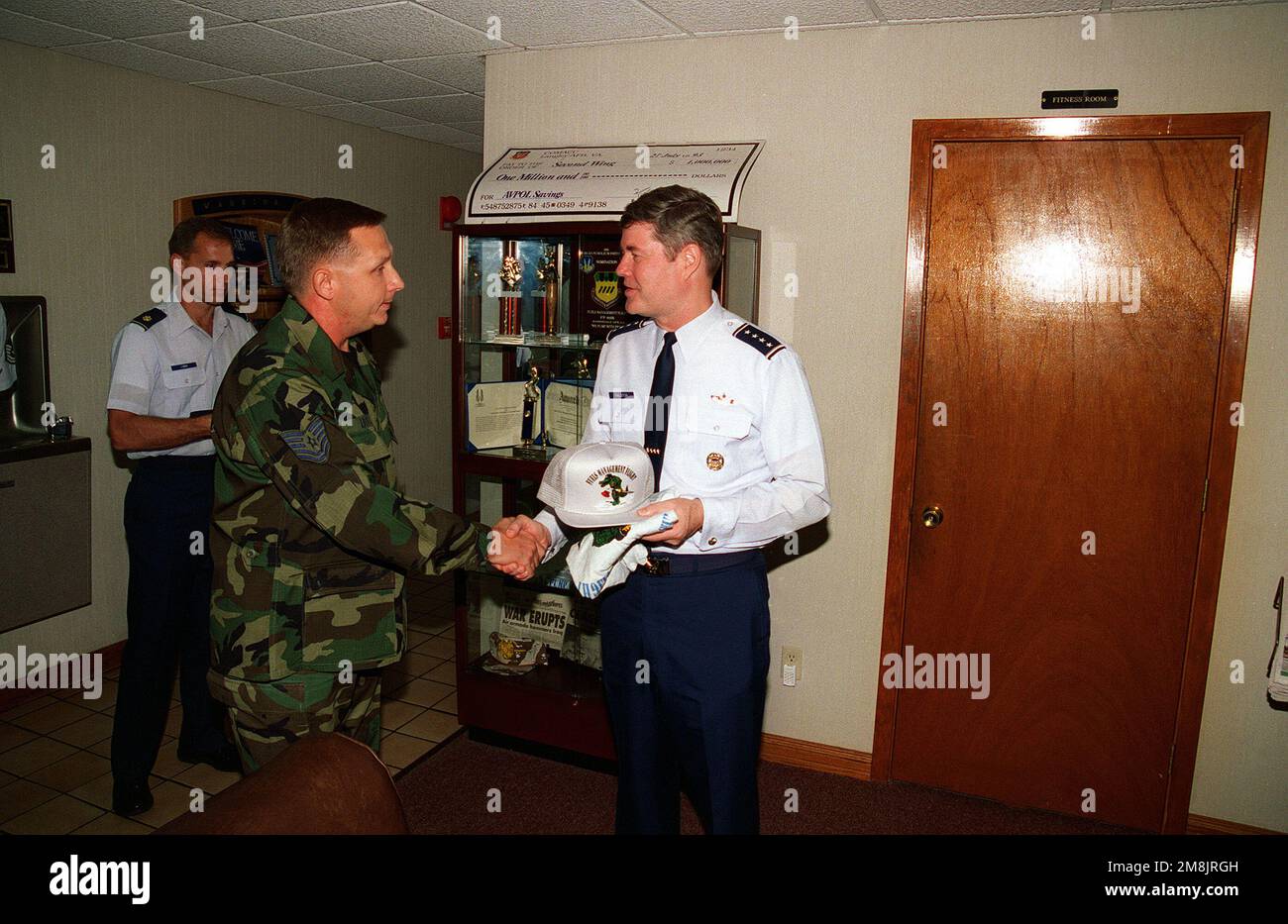 Technical Sergeant Randy Little, 2nd Supply Squadron, presents General Ralston, COMACC, with ...
