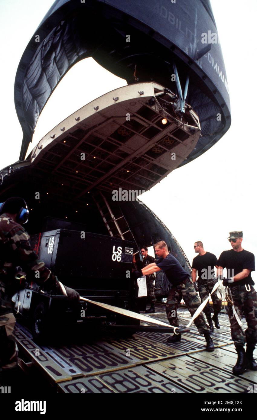 Members from the Tactical Air Lift Control Element (TALCE) off load ...