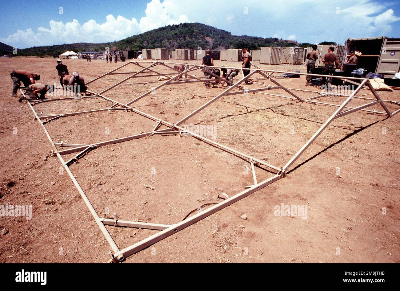 Joint Task Force 160 personnel lay out a frame for a tent that will be ...