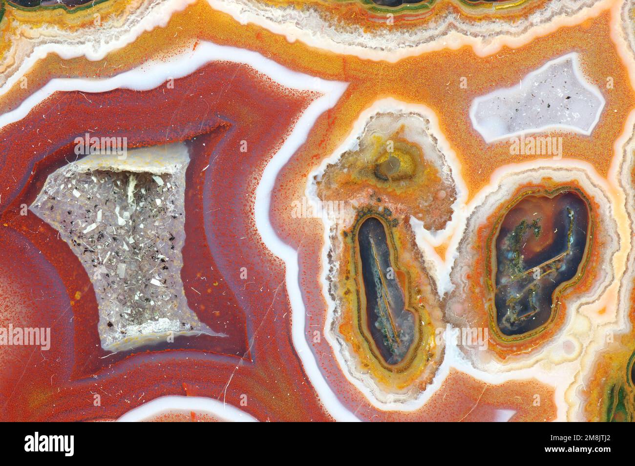 A cross section of the agate stone with quartz geode. Multicolored ...