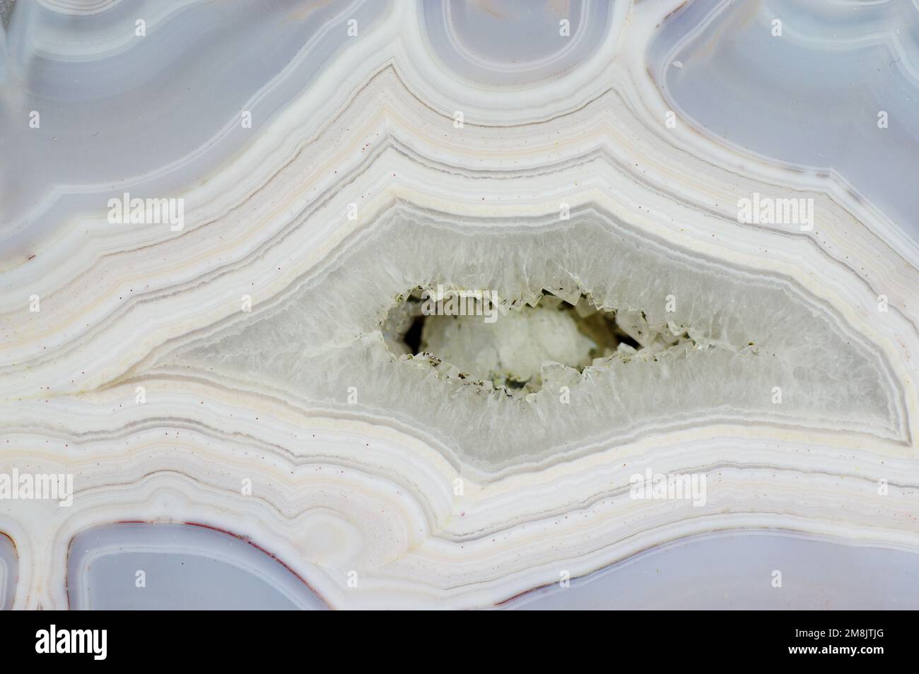 A cross section of the agate stone with quartz geode. Multicolored ...