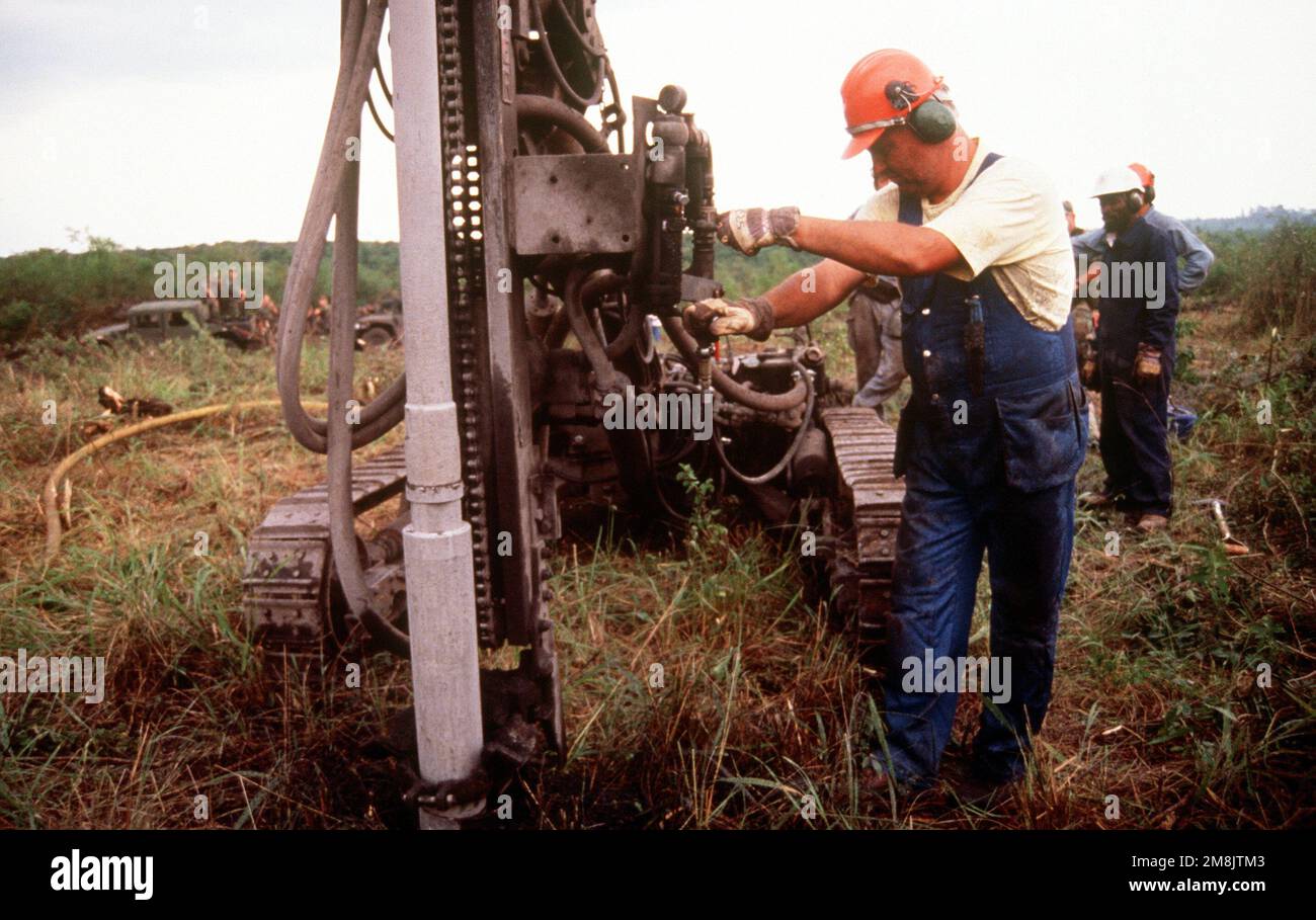 Civilian contracted water personnel drill for water near refugee camps ...
