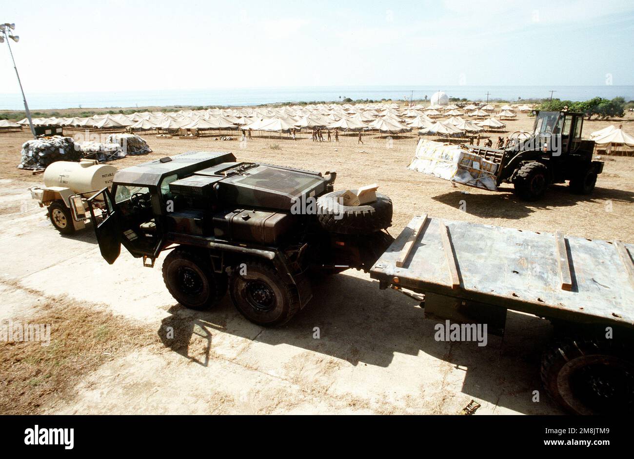 A forklift operator moves supplies into position at Camp India. The ...
