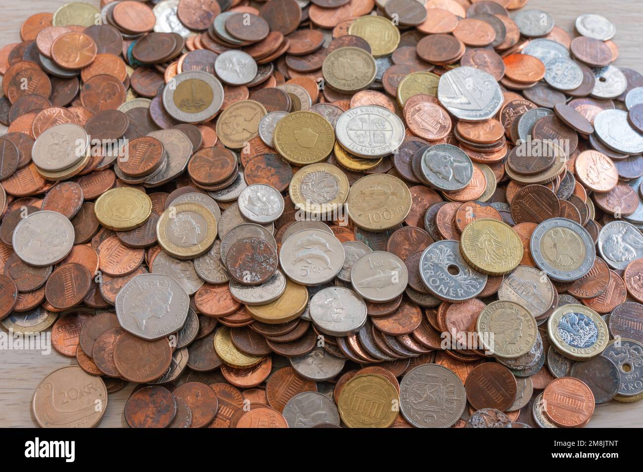 Coins gathered from international travel Stock Photo - Alamy