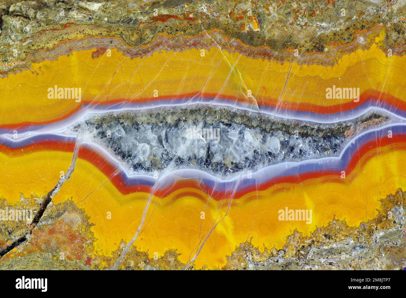 A cross section of the agate stone with quartz geode. Multicolored ...