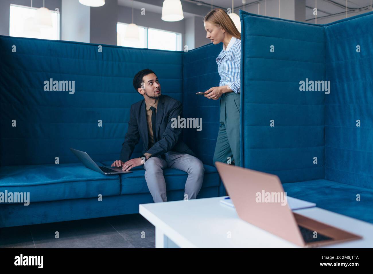 Woman came up to man with laptop computer to talk Stock Photo - Alamy