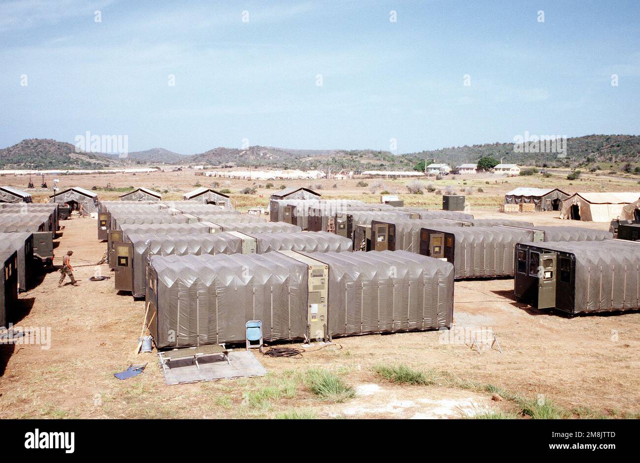 Expandable shelters (EXPs) are set up in rows. The shelters will house ...
