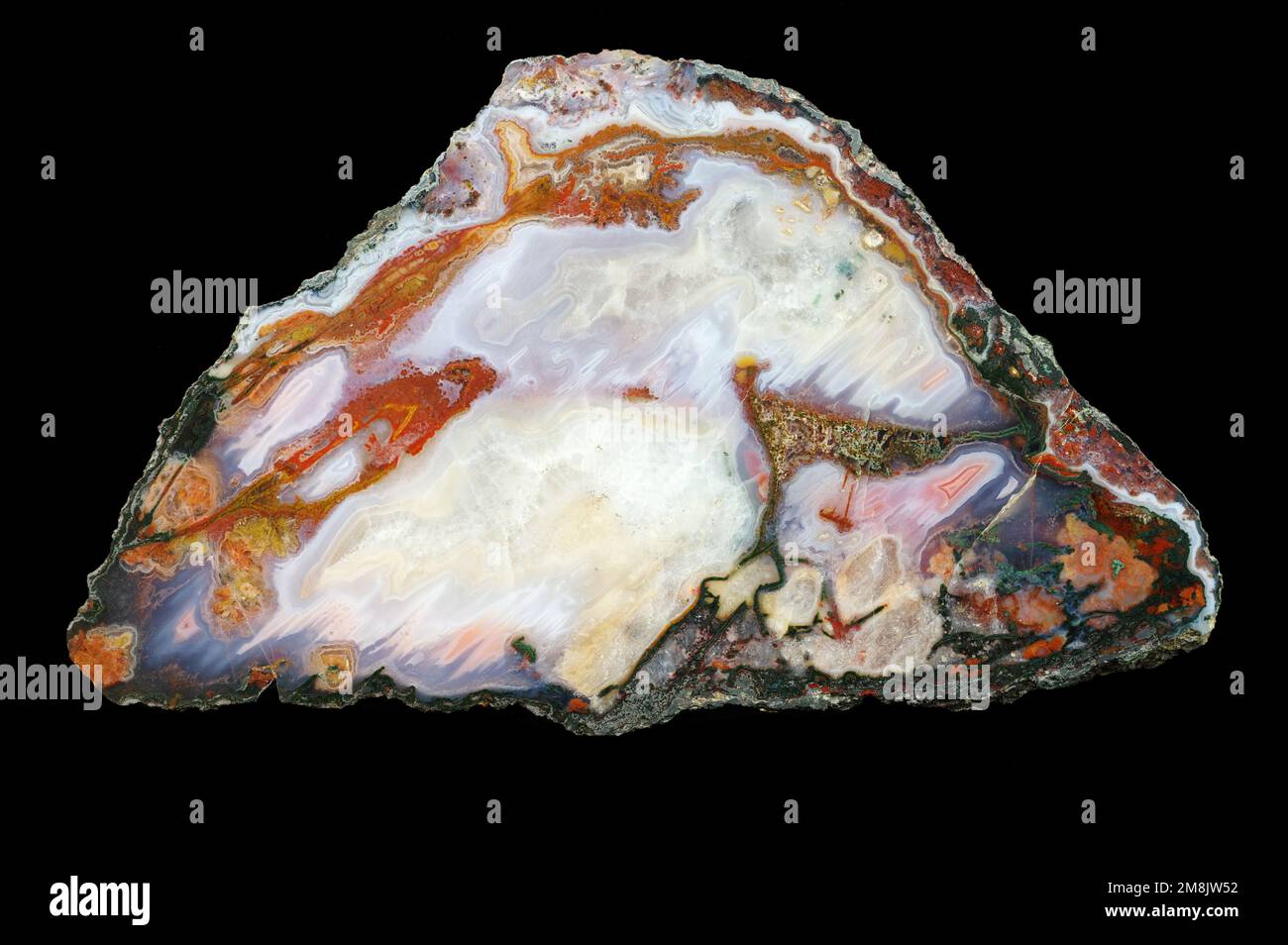 A cross section of the agate stone with quartz geode. Multicolored ...