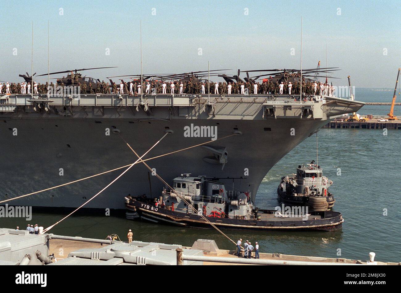 The large harbor tugs ANOKA (YTB-810) and PIQUA (YTB-793) move in under ...