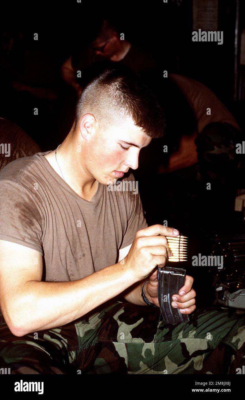 PFC. Dustin Laro, Charley Company, 187th Battalion, loads M-16 ...