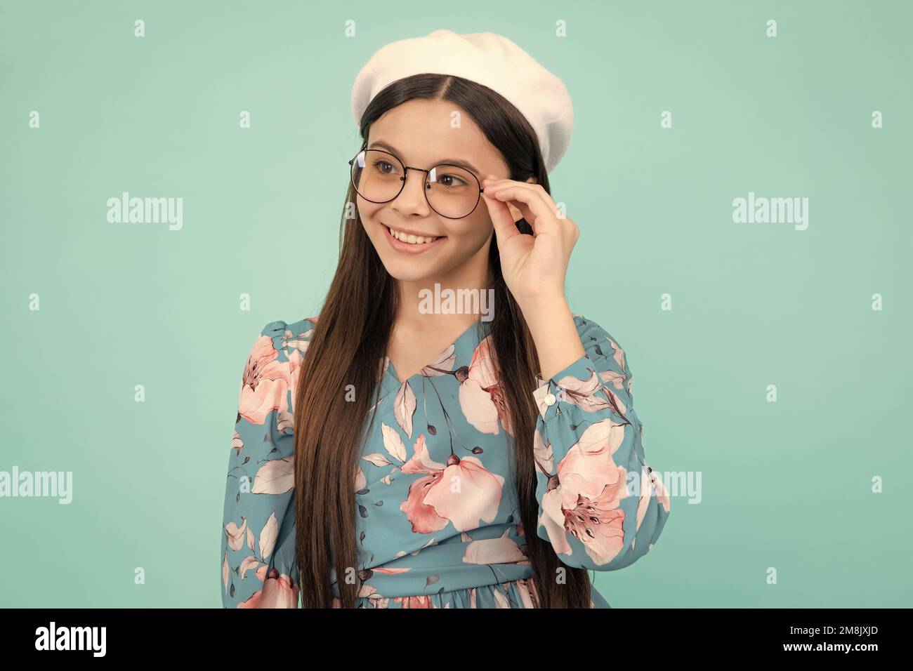 Headshot portrait of cute teenager child girl isolated on blue studio ...