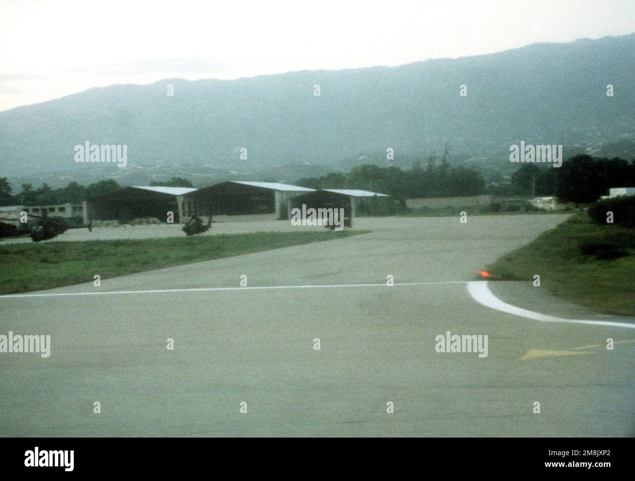 AH-1 Cobra helicopters are parked at the 270 end of the runway, North ...