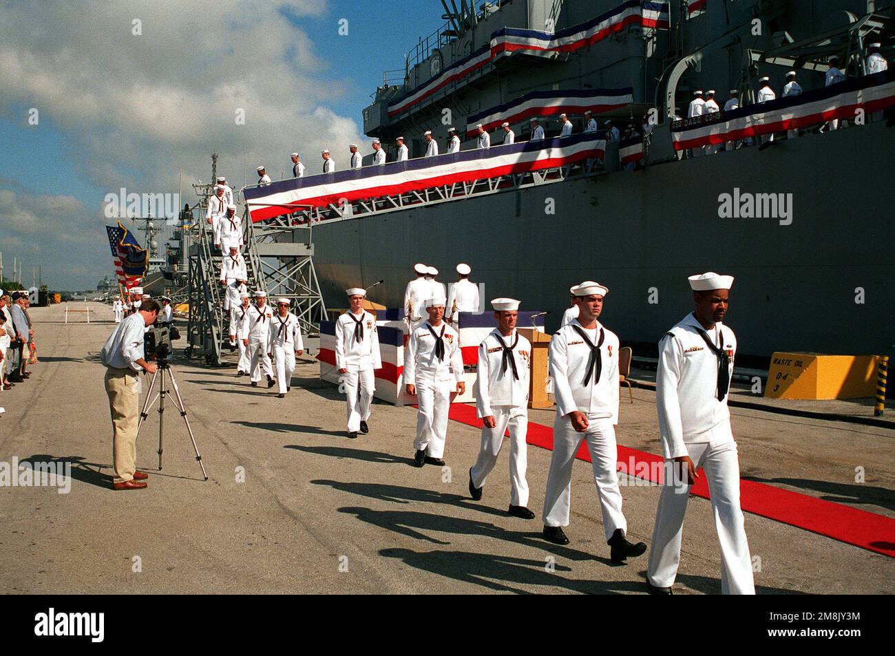 Crew members of the guided missile cruiser USS DALE (CG-19) march down ...