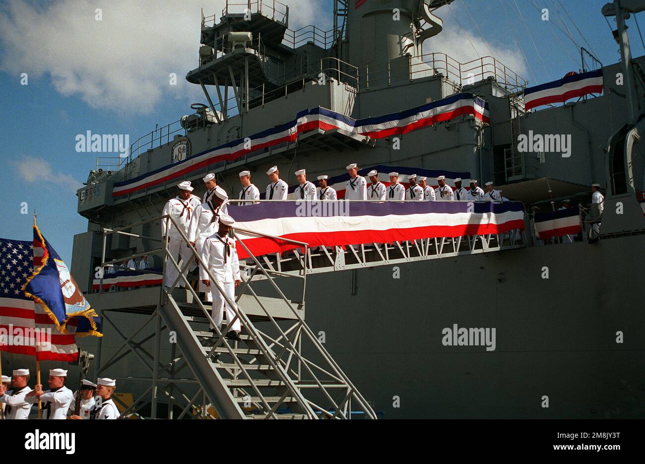 Crew members of the guided missile cruiser USS DALE (CG-19)begin to ...
