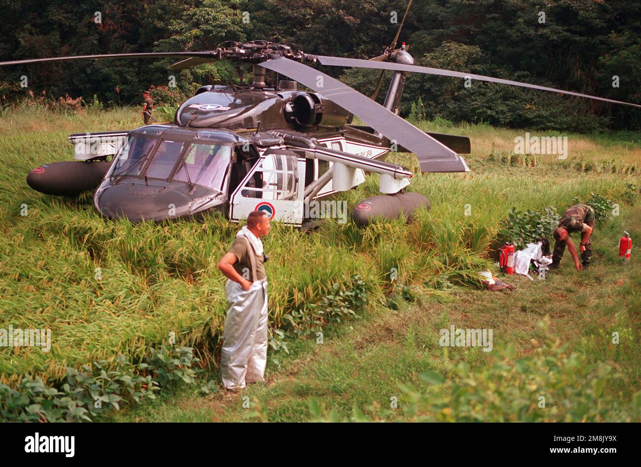 Crash crew personnel look over the area where a US Army Black Hawk ...